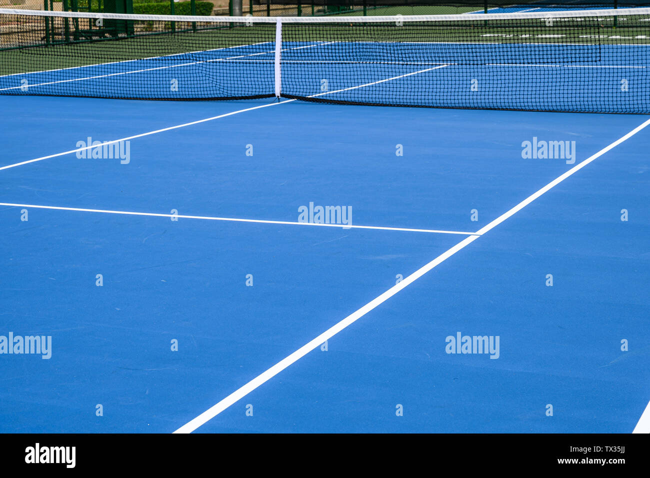 Whole blue tennis court, synthetic rubber field Stock Photo - Alamy
