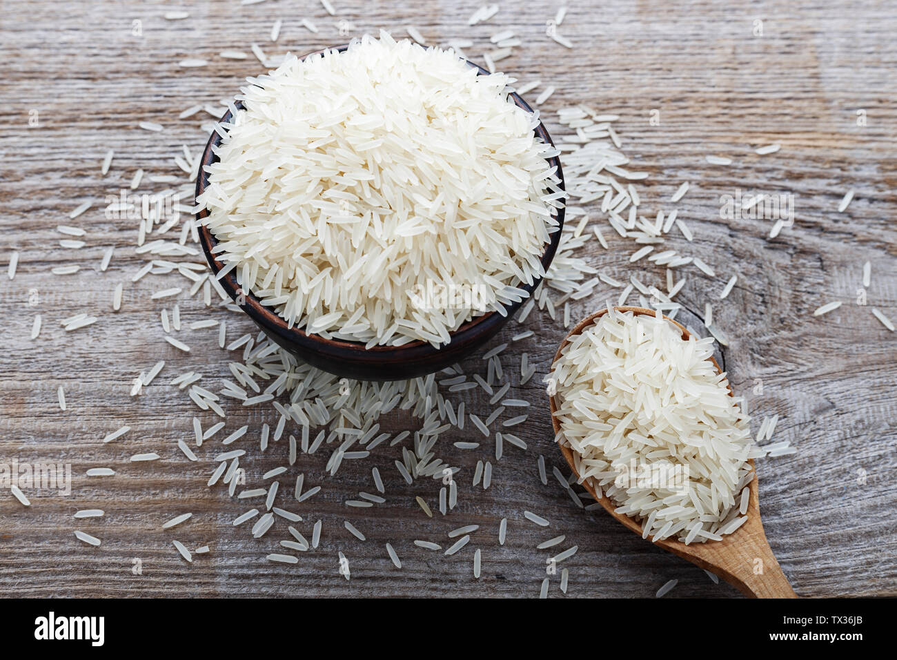 food background. white rice in a wooden spoon. top view Stock Photo - Alamy