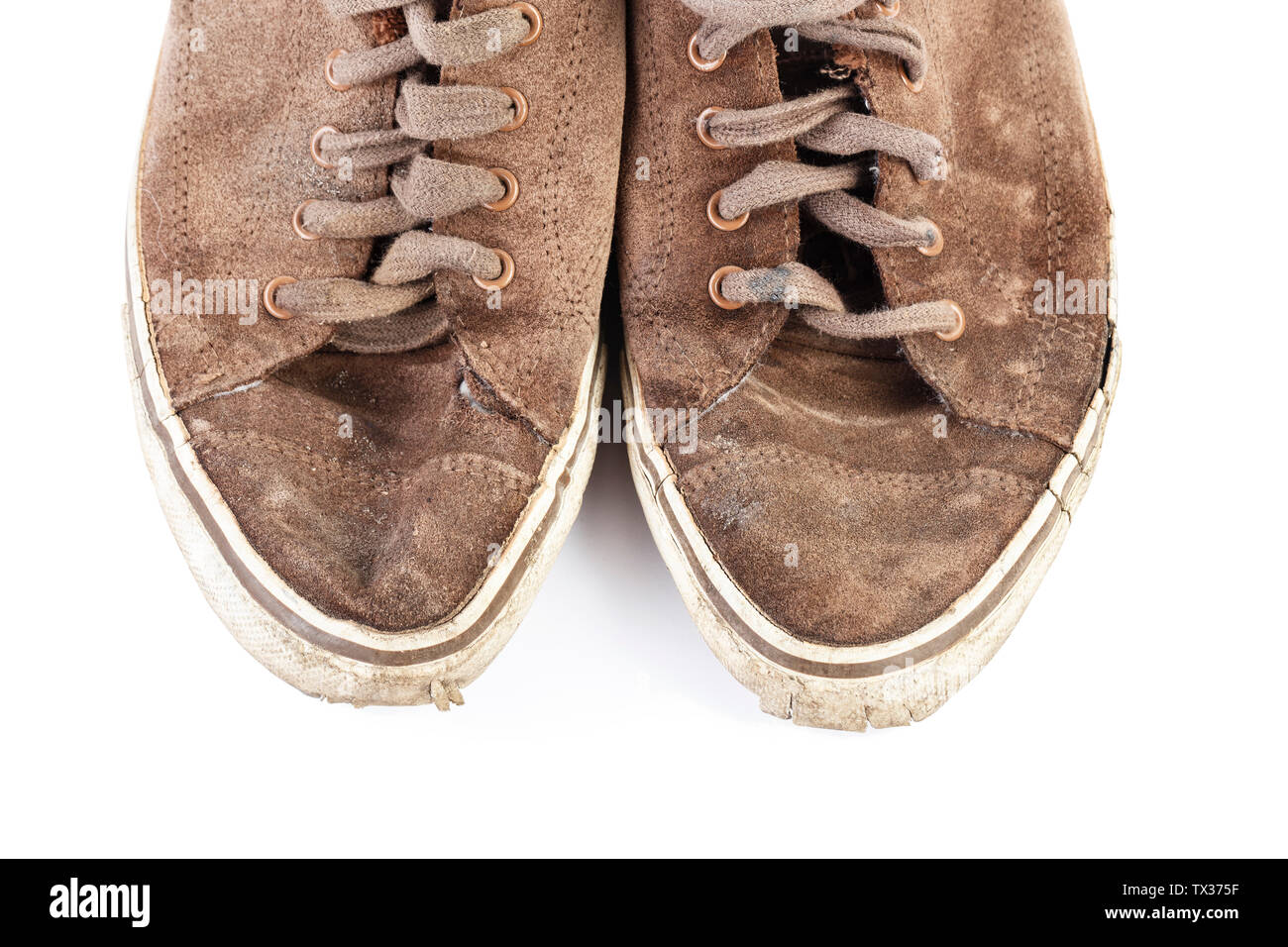 Old and dirty brown sneakers isolated on white background. Top view ...