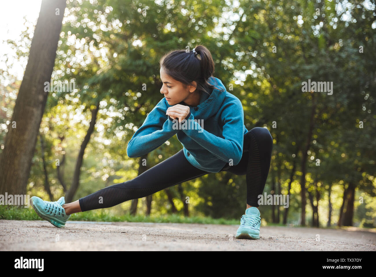 Beautiful young fitness woman doing morning exercising at the park ...