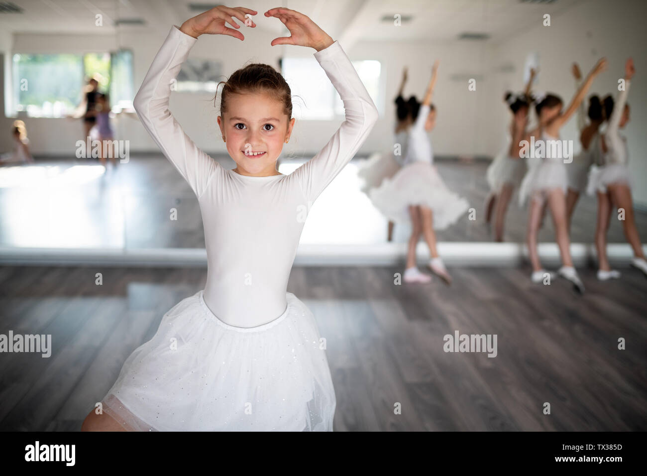 Group of fit happy children exercising ballet in studio together Stock ...