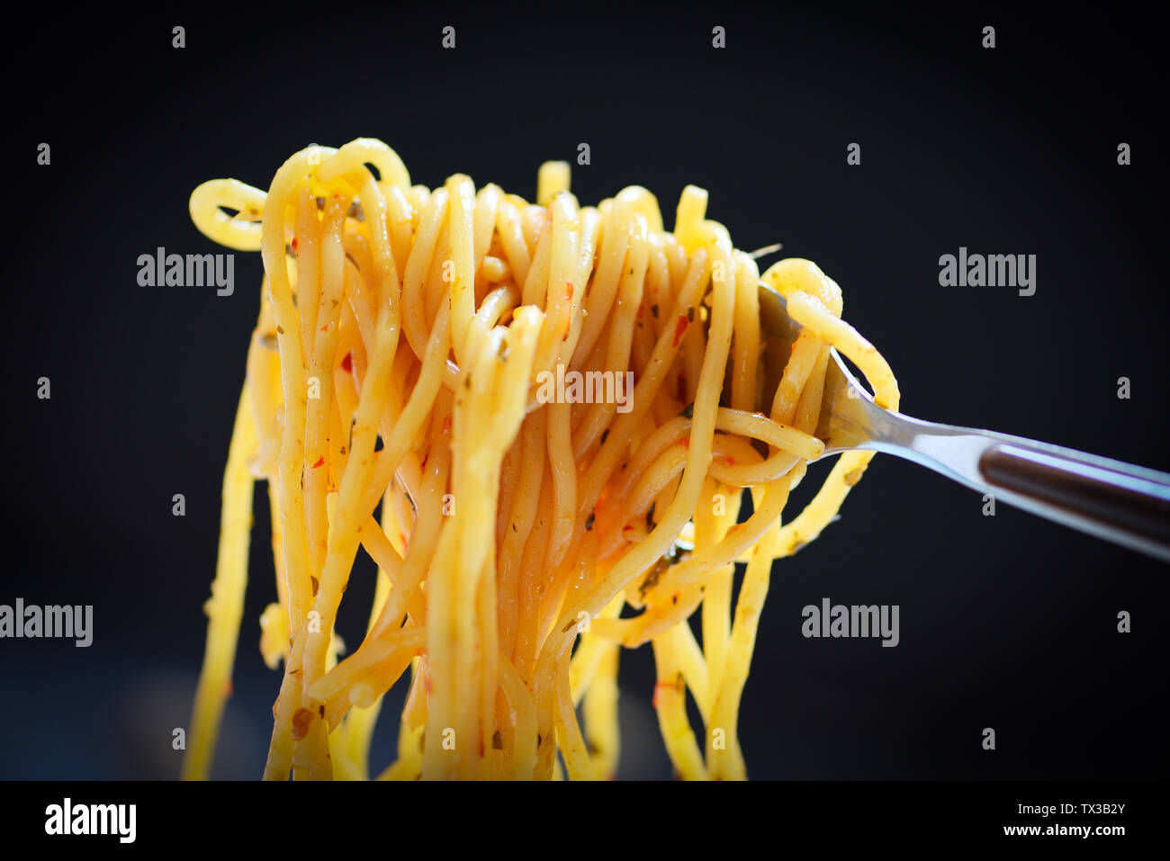 Spaghetti fork on dark black background / Traditional delicious food ...