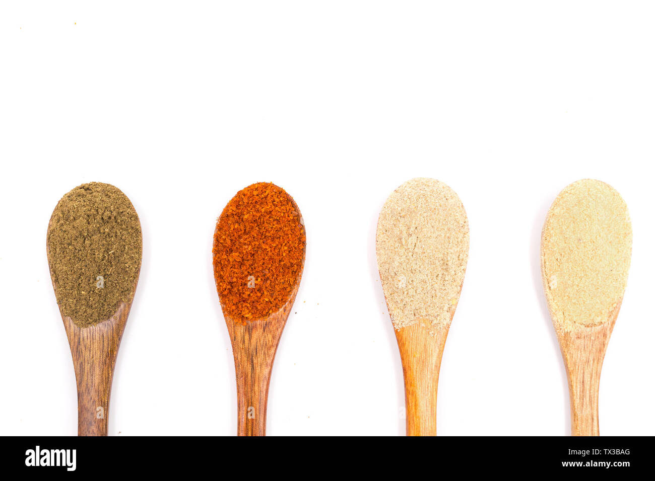 Multiple wooden spoons filled with various seasonings Stock Photo - Alamy