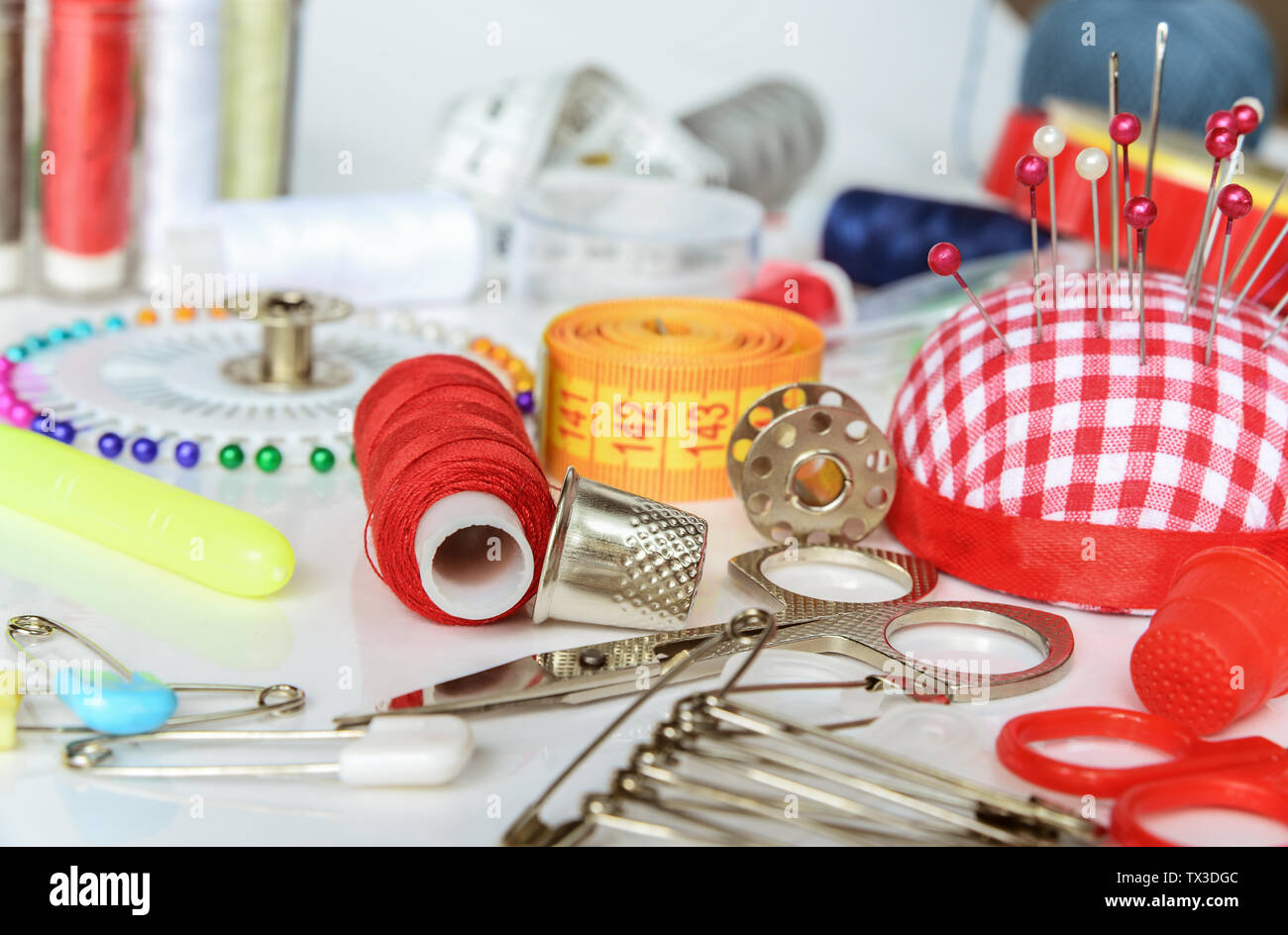 Set of objects for needlework: threads, needles, pins, scissors, beads ...