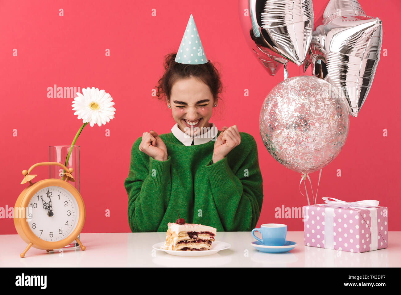 Cheerful young nerd student girl celebrating her birthday and rejoices ...