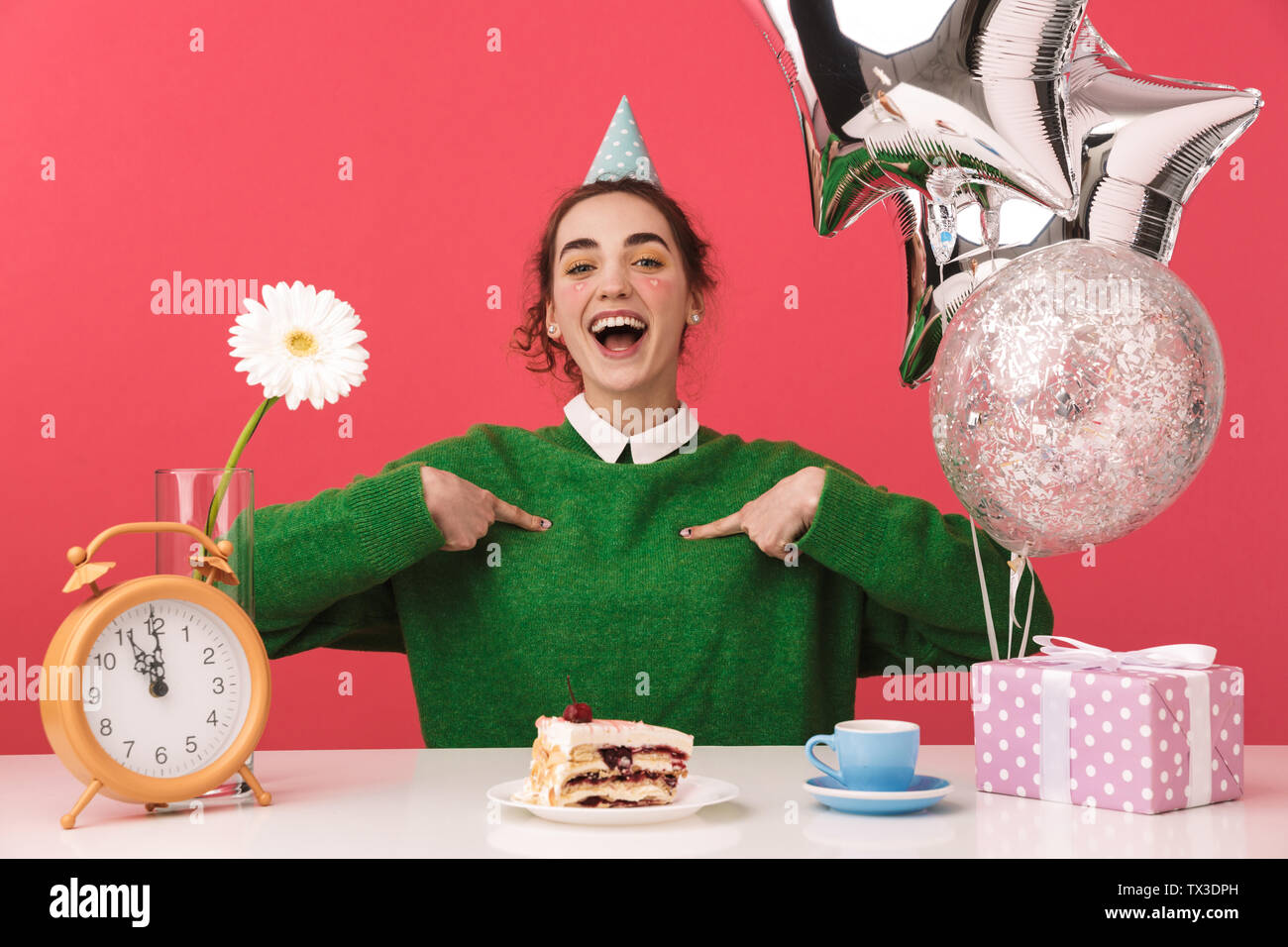 Cheerful young nerd student girl celebrating her birthday and pointing ...