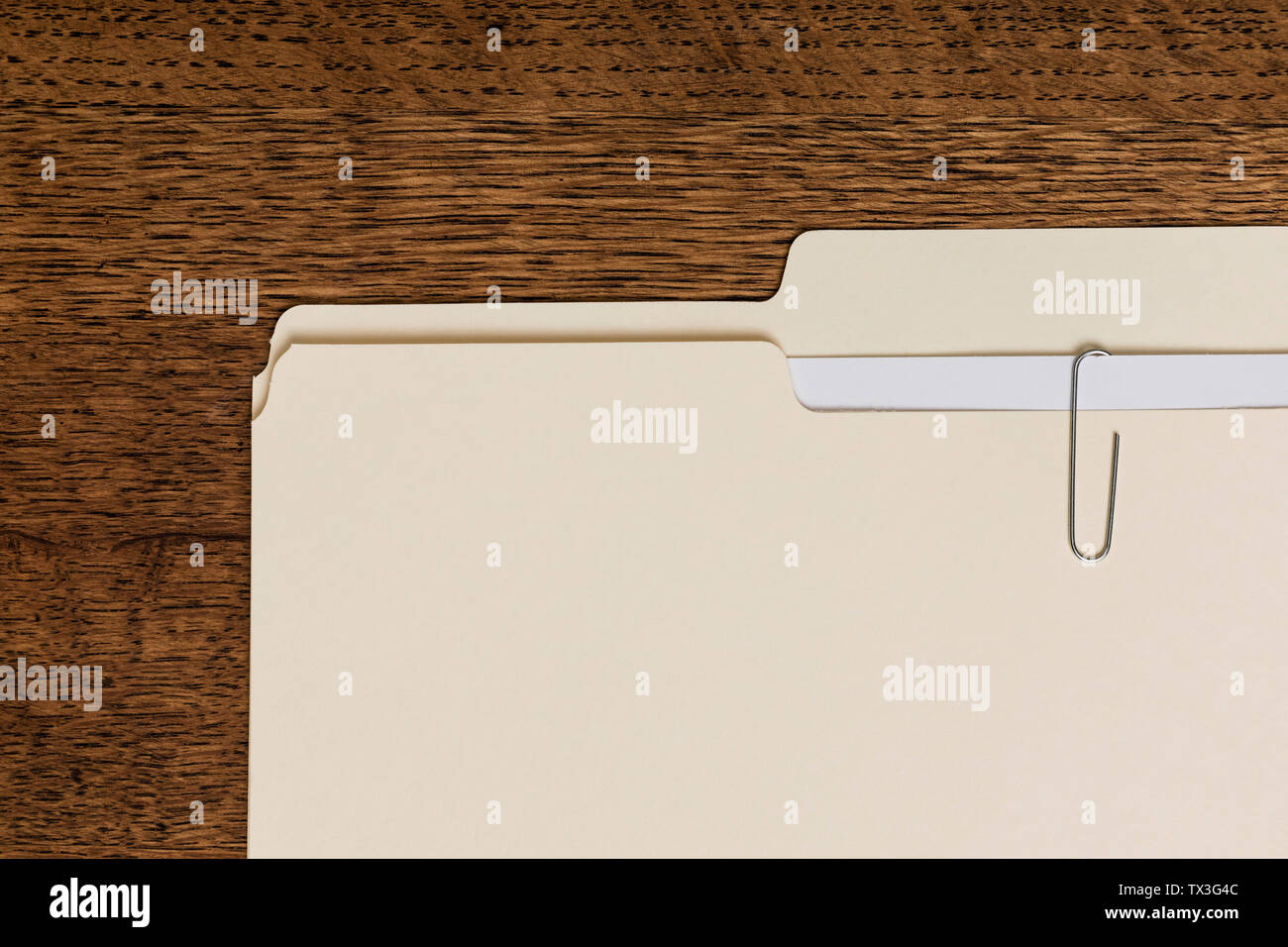 View from above manila folder and paperclip on wooden surface Stock ...