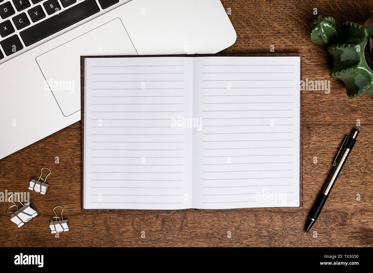 View from above blank, lined notebook and pen at laptop Stock Photo - Alamy