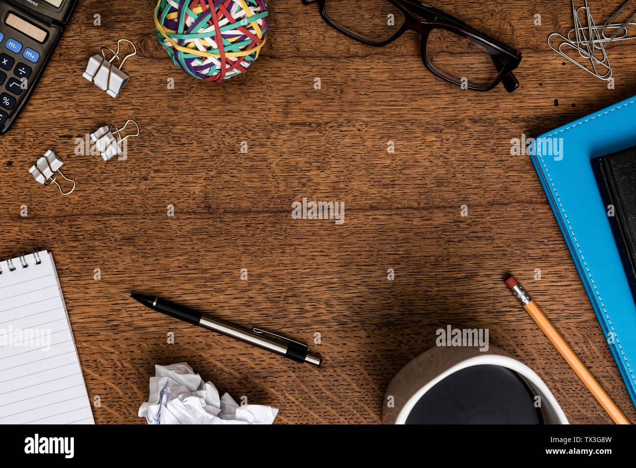 View from above office supplies on wooden desk Stock Photo - Alamy