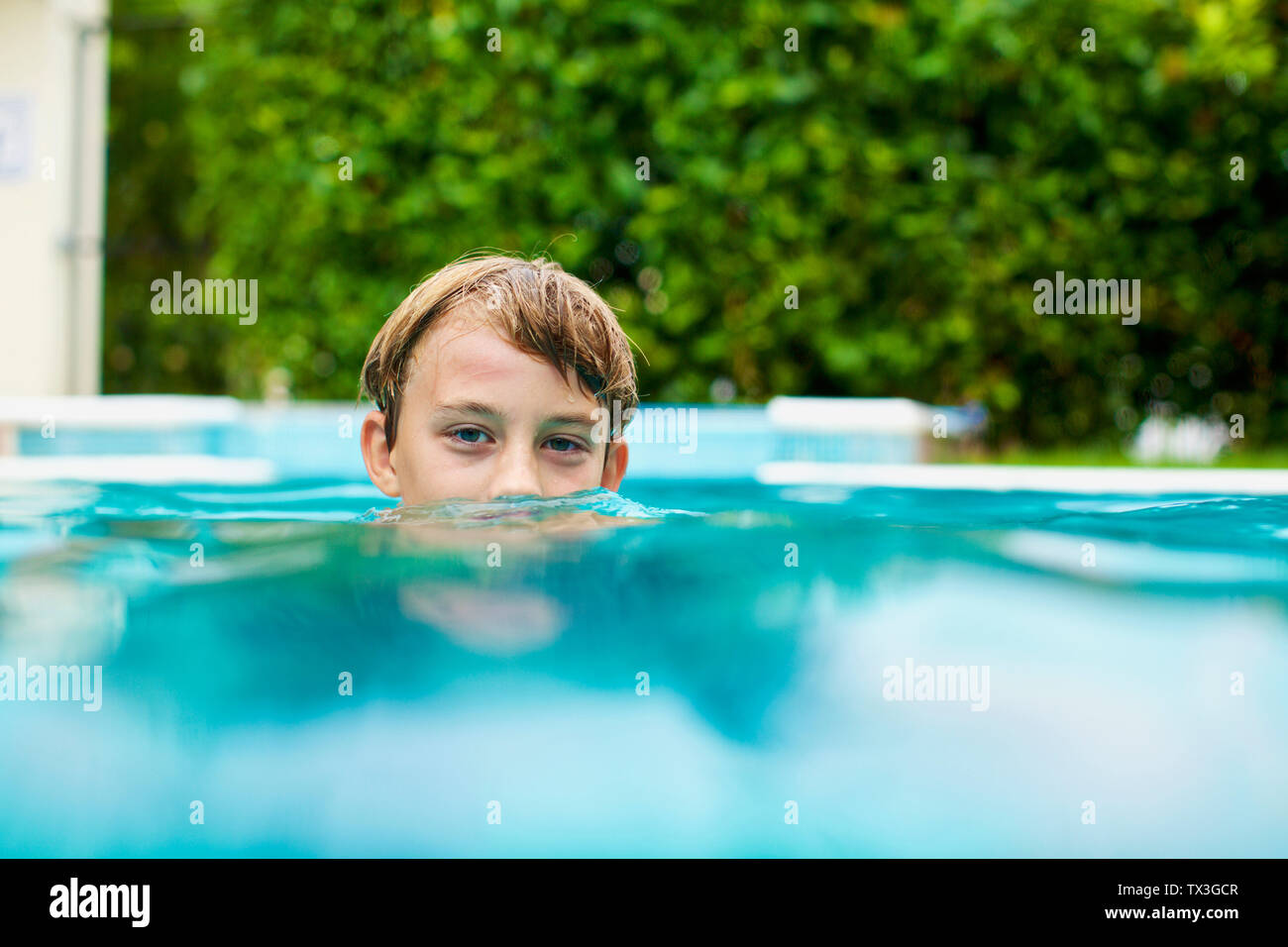 Portrait boy swimming in swimming pool Stock Photo - Alamy