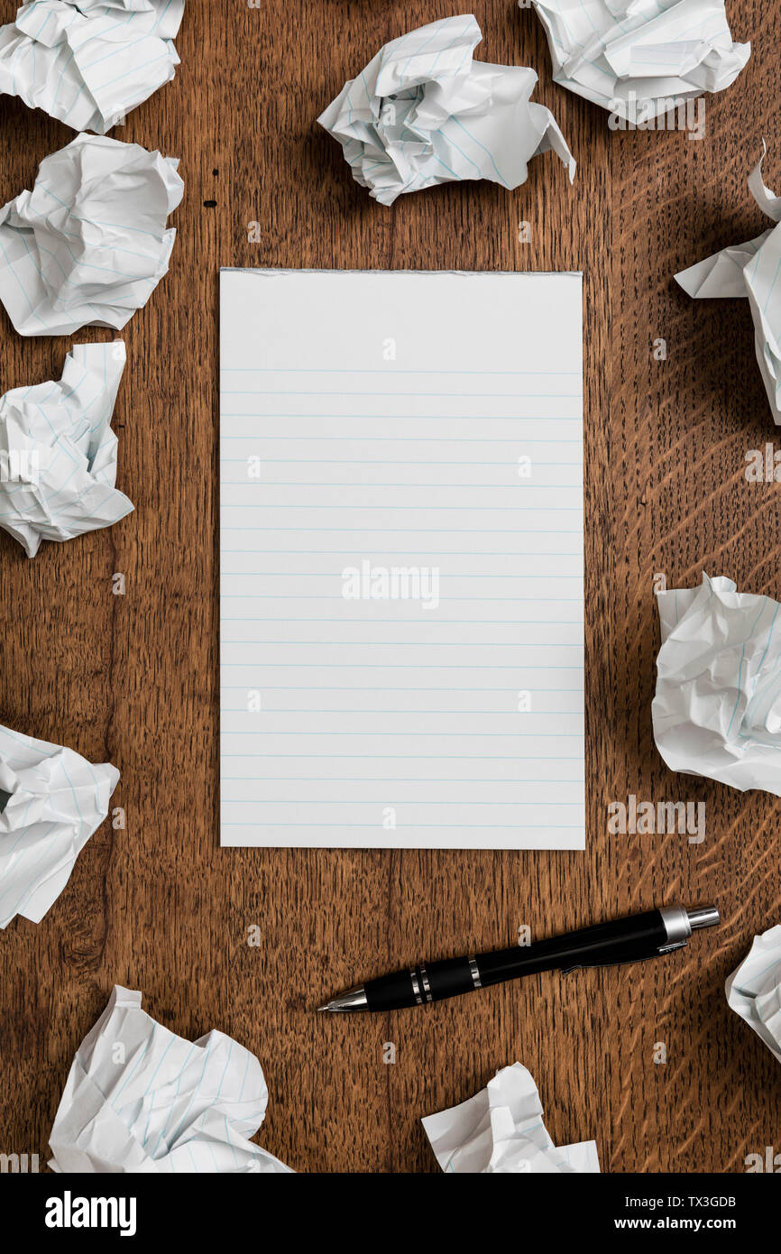 View from above crumpled paper around blank notepad Stock Photo - Alamy