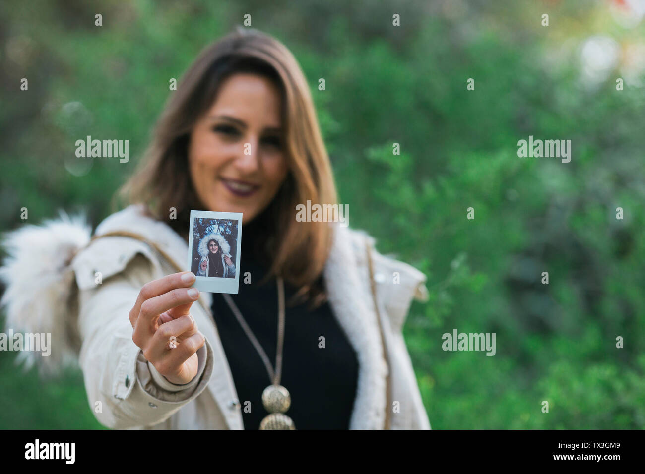 Portrait woman showing instant photograph Stock Photo - Alamy