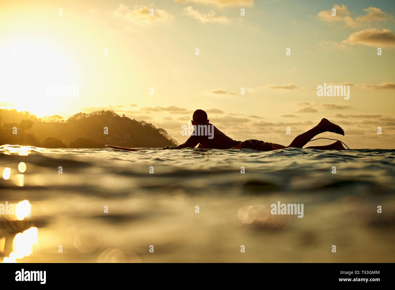 Surfer paddling in ocean hi-res stock photography and images - Alamy