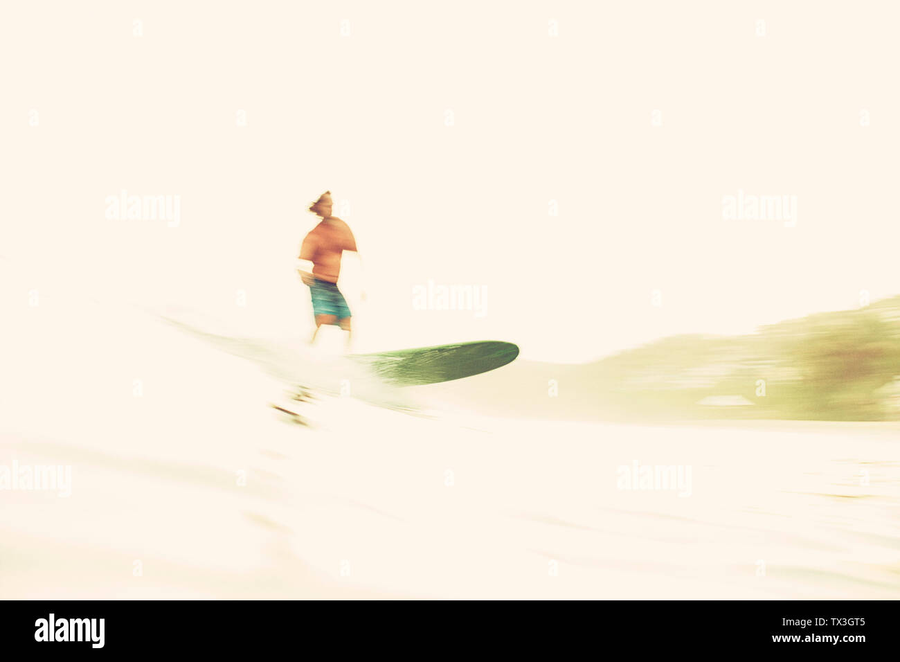 Male surfer riding wave on sunny ocean Stock Photo - Alamy