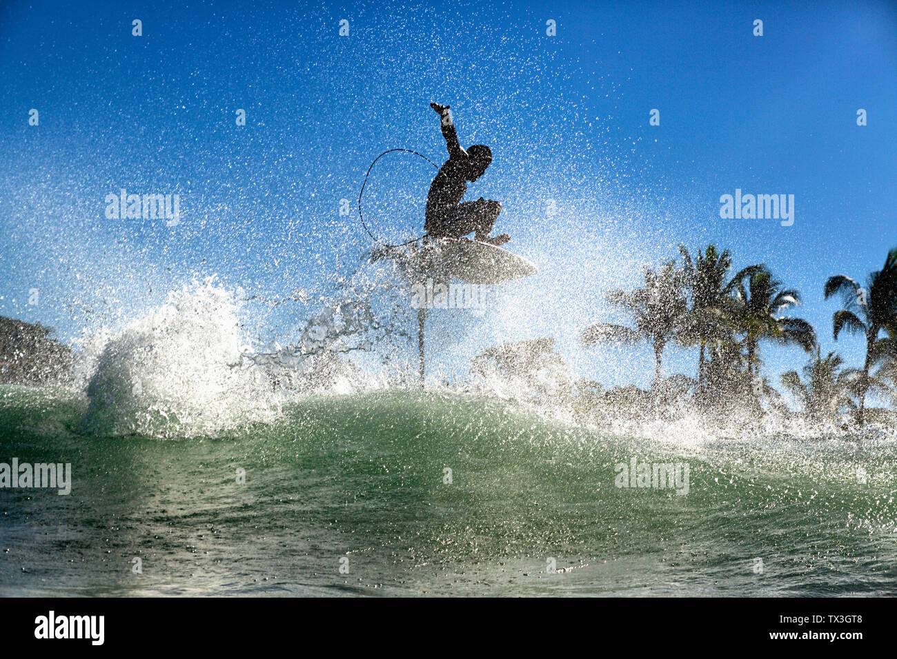 Male surfer catching air above ocean wave, Sayulita, Nayarit, Mexico ...