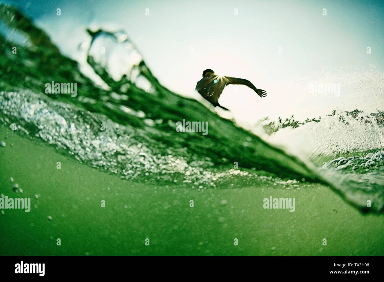 Male surfer making cutback from behind ocean wave Stock Photo - Alamy