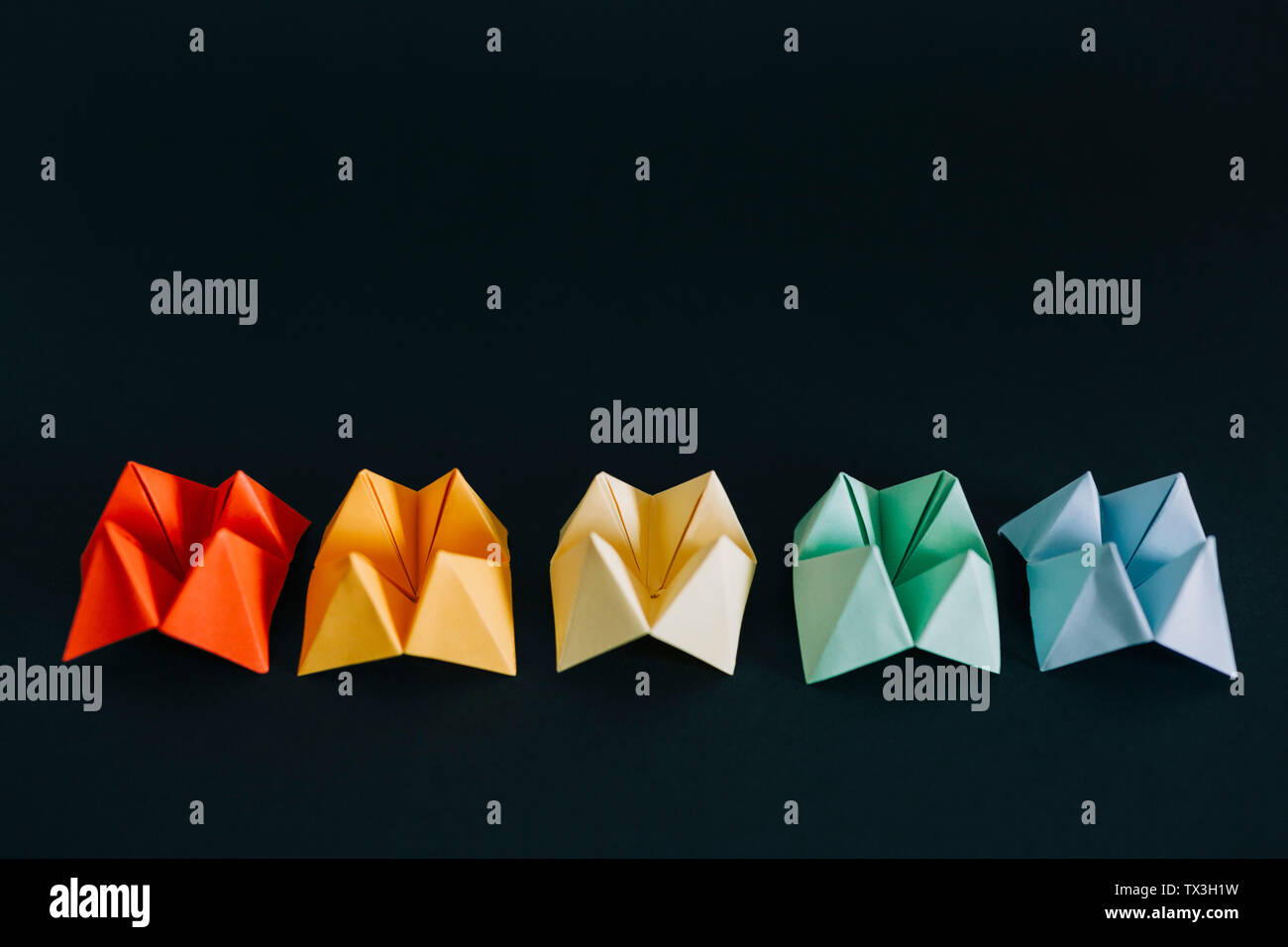 Rainbow multicolored origami fortune tellers on black background Stock ...