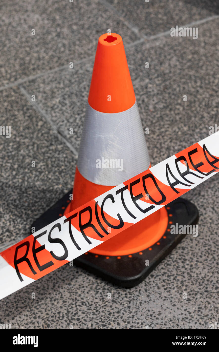Traffic cone and Restricted Area tape Stock Photo - Alamy