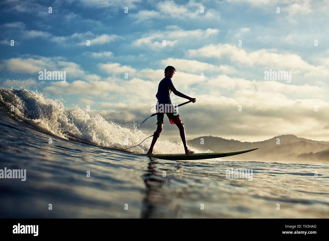 Silhouette boy paddleboarding over ocean wave, Sayulita, Nayarit, Mexico Stock Photo - Alamy