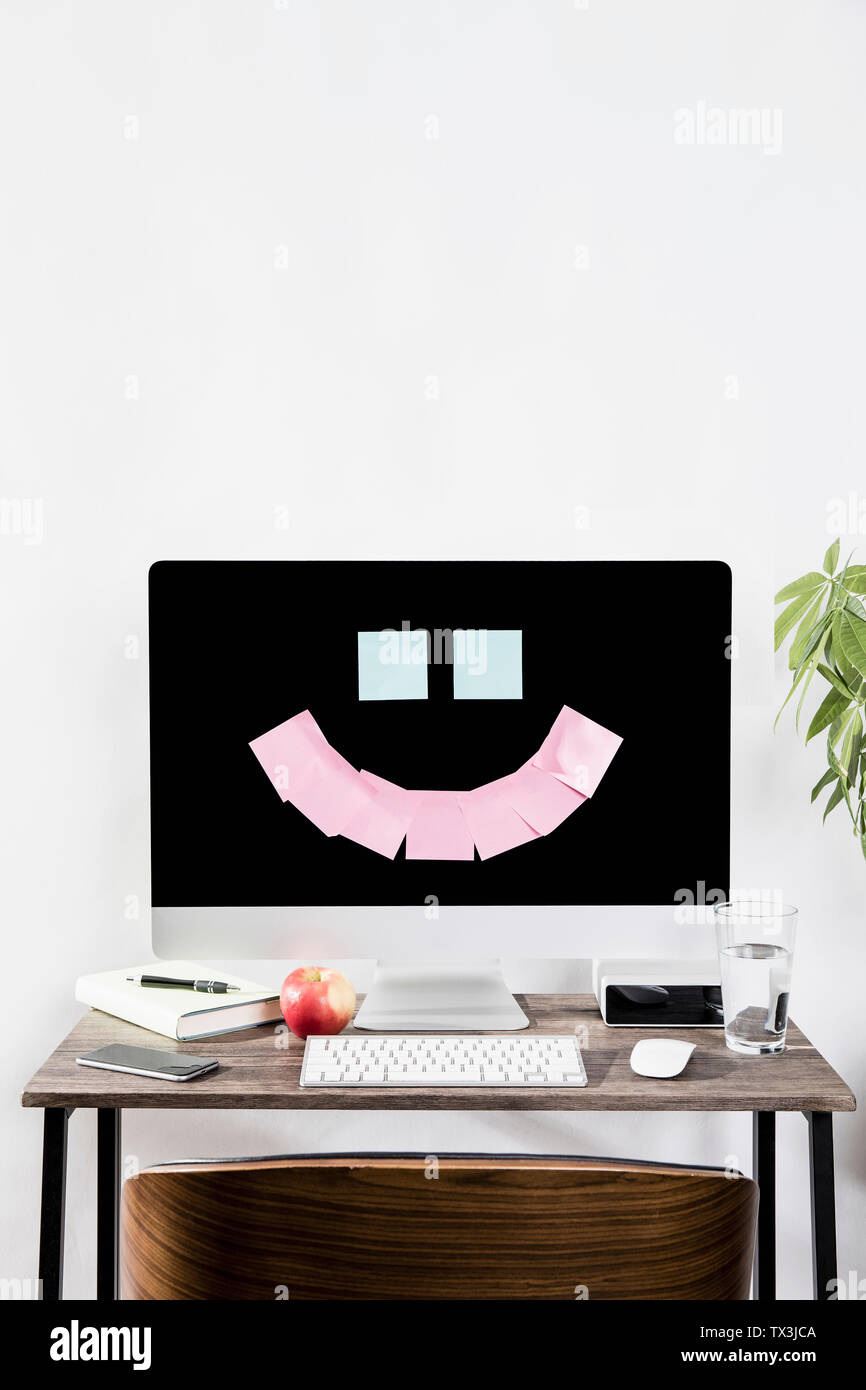Adhesive notes forming smiley face on computer in office Stock Photo ...