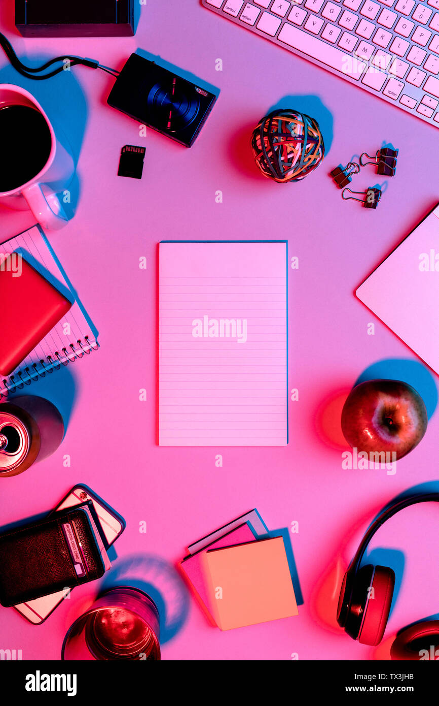 View form above blank notepad on desk surrounded by office supplies ...