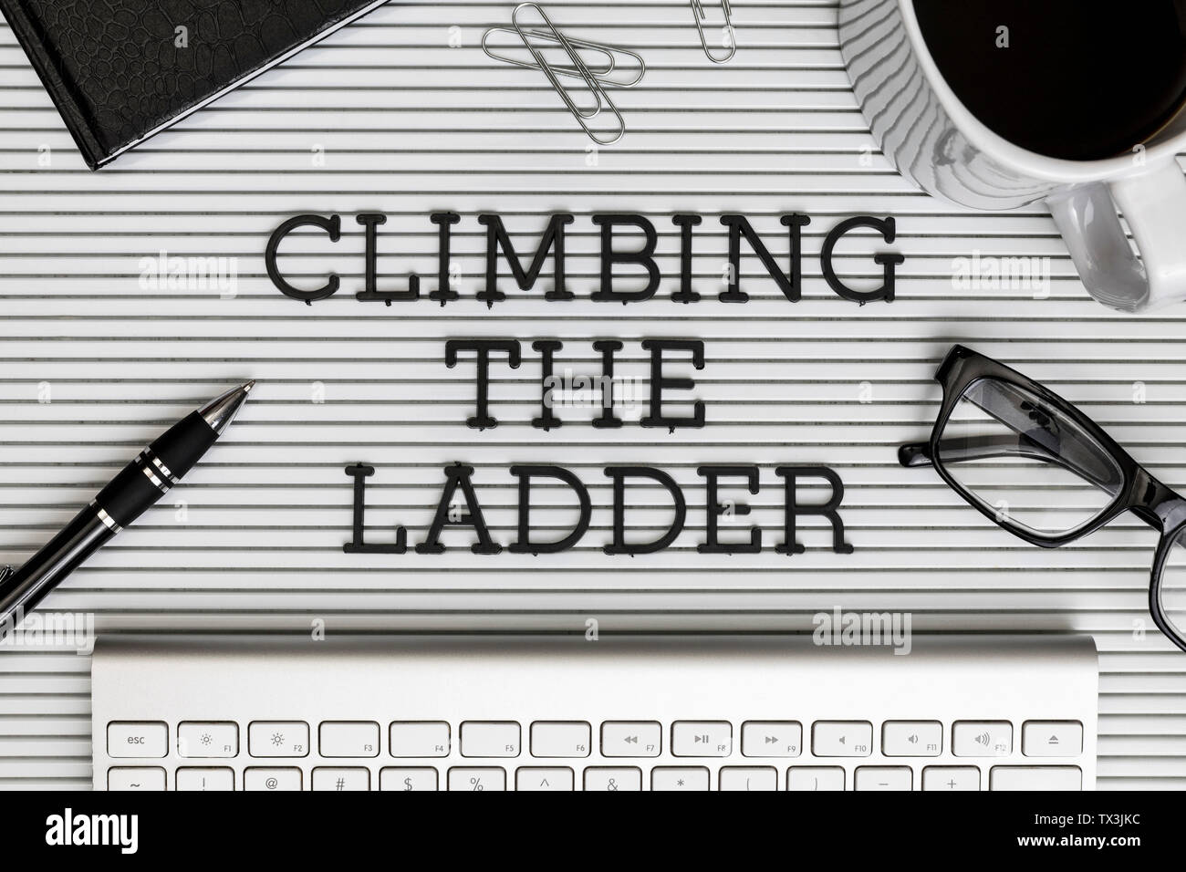 View from above "Climbing the Ladder" text on desk Stock Photo - Alamy