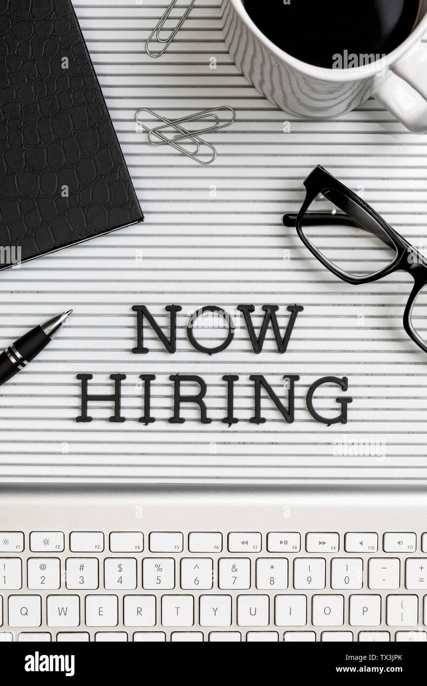View form above "Now Hiring" text on desk above computer keyboard Stock ...