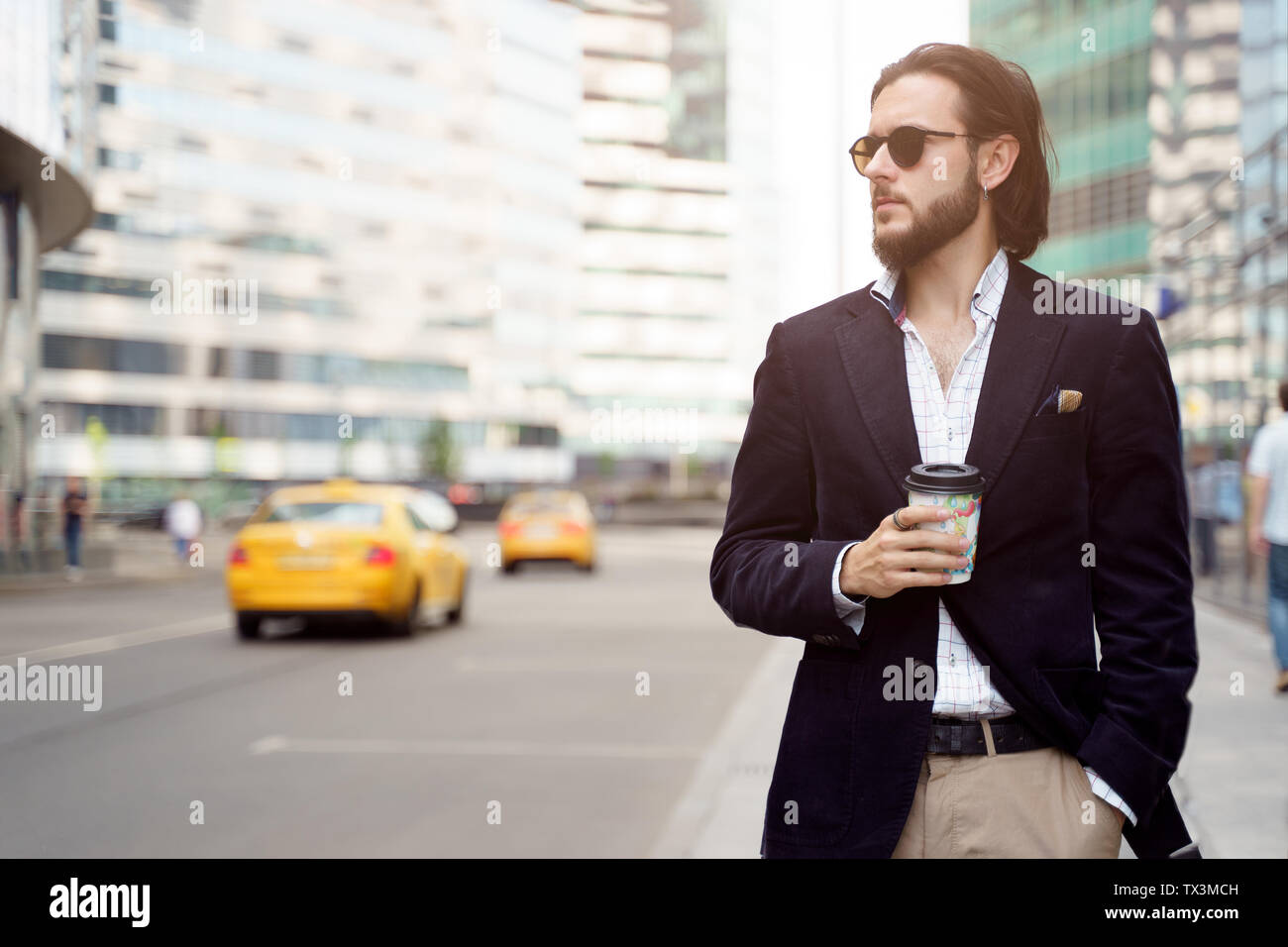Photo of brunette with beard and earring in ear looking to side with ...