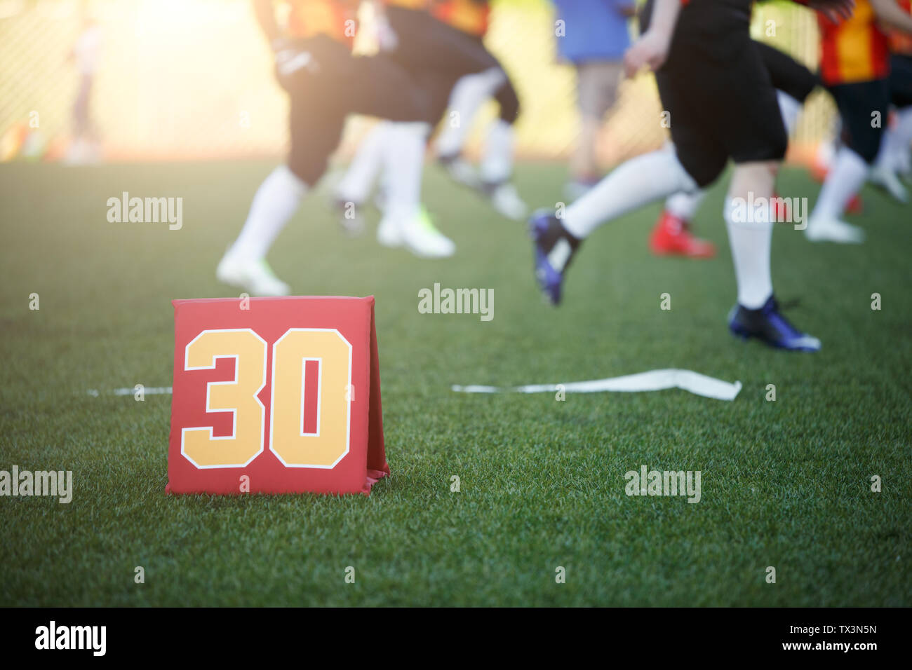Picture of soccer field with number thirty running football players on ...