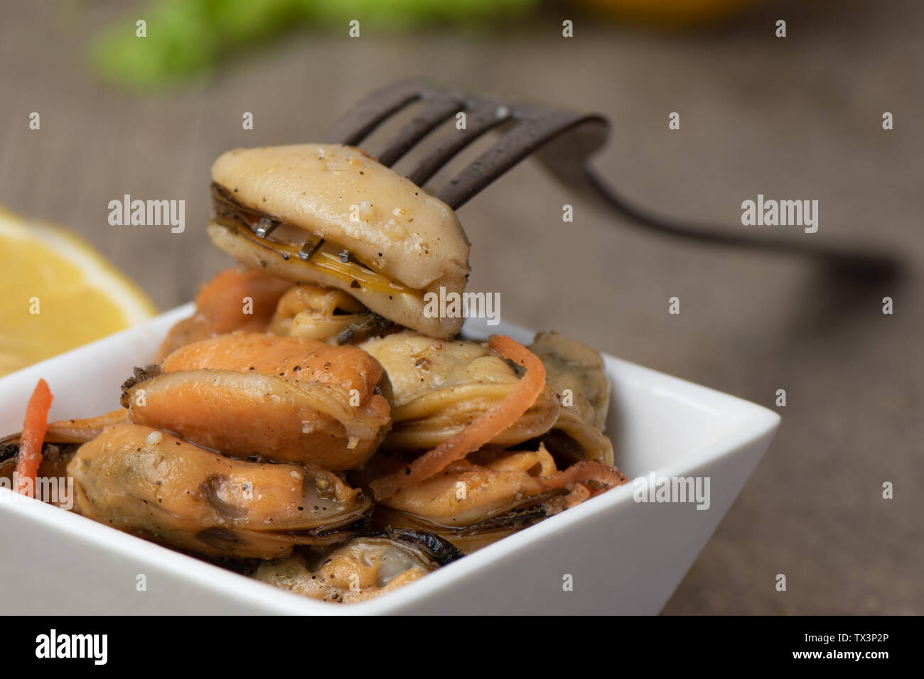 Pickled mussels with carrot, lemon juice and oil Stock Photo - Alamy