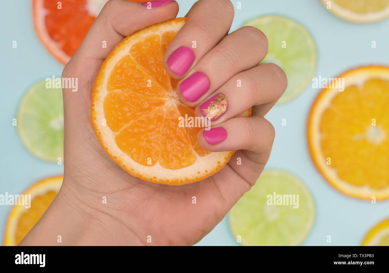 Female hand with pink nail design with gold foil Stock Photo - Alamy