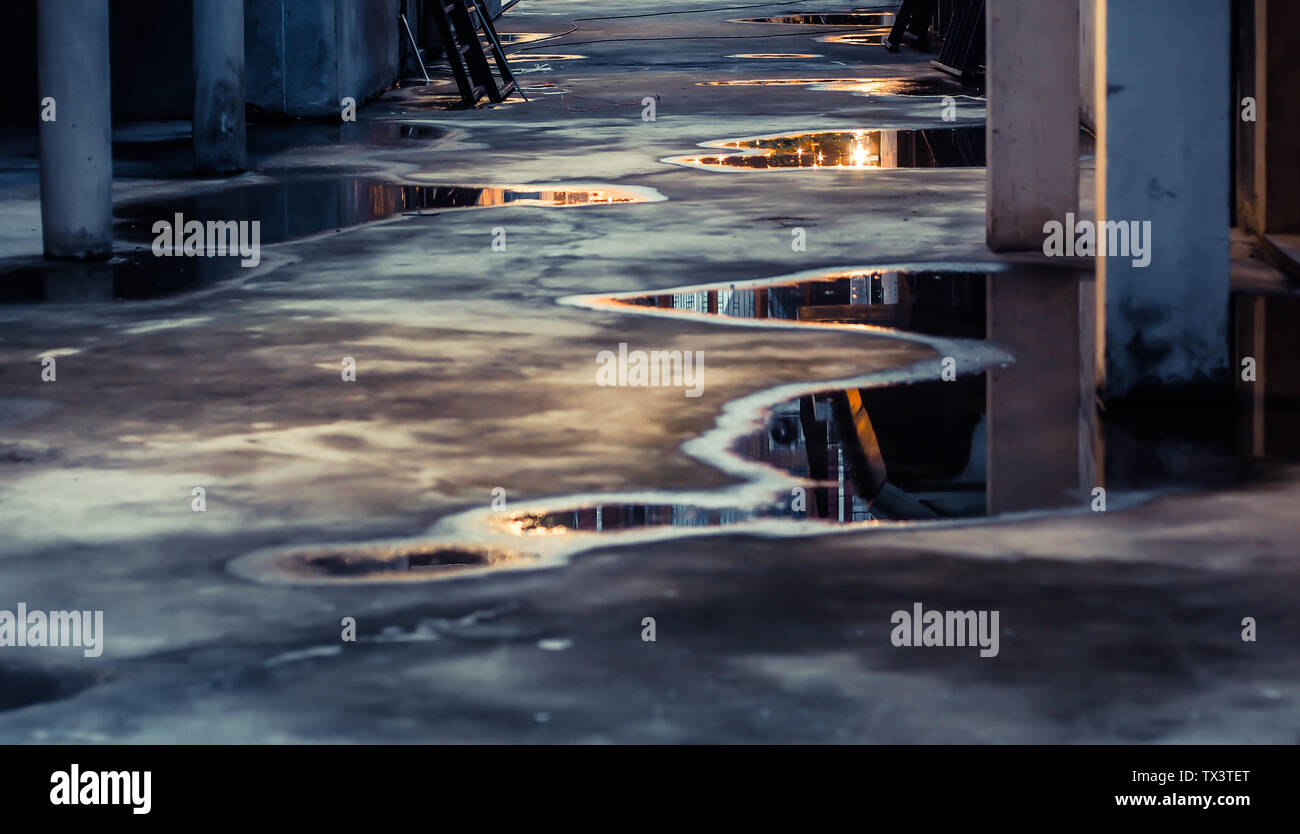 Puddle water reflection on ground. Parking lot with abstract water ...