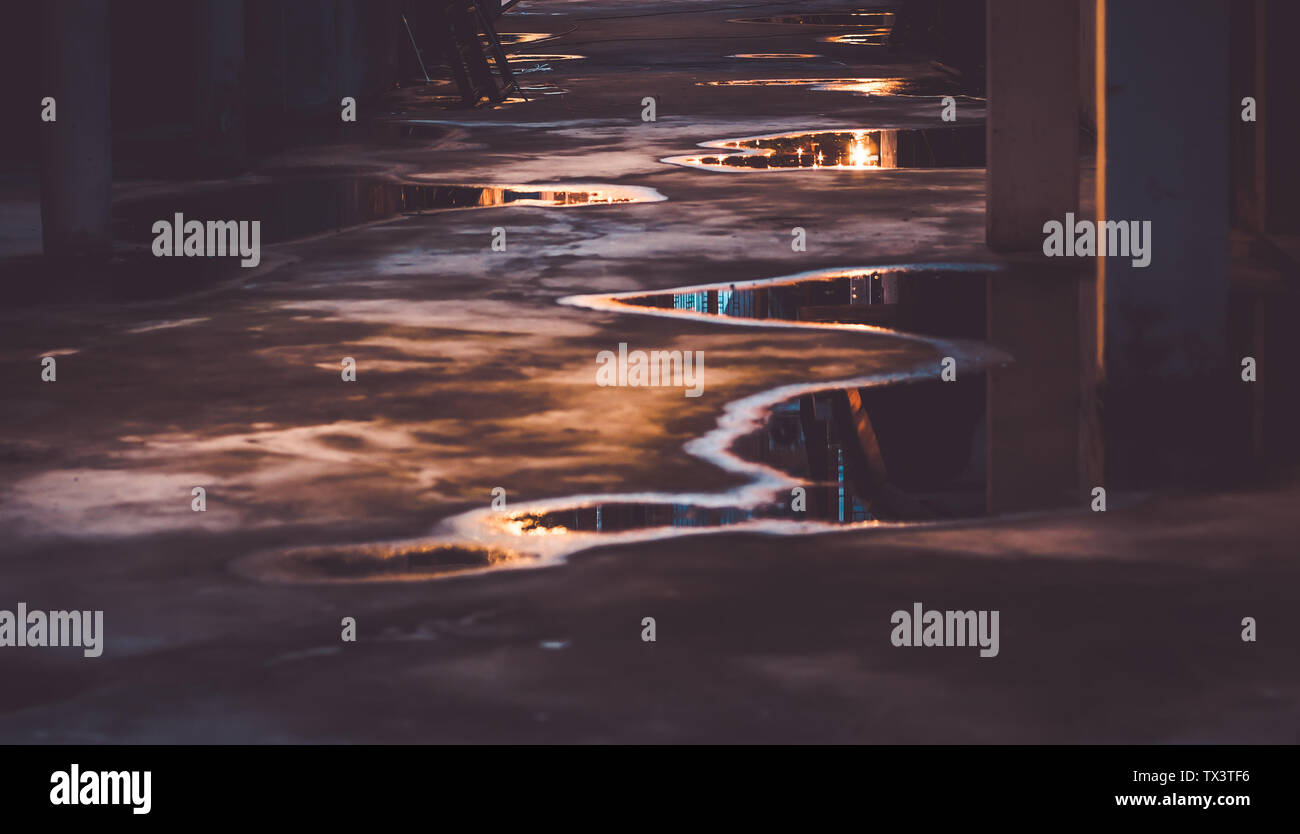 Puddle water reflection on ground. Parking lot with abstract water ...