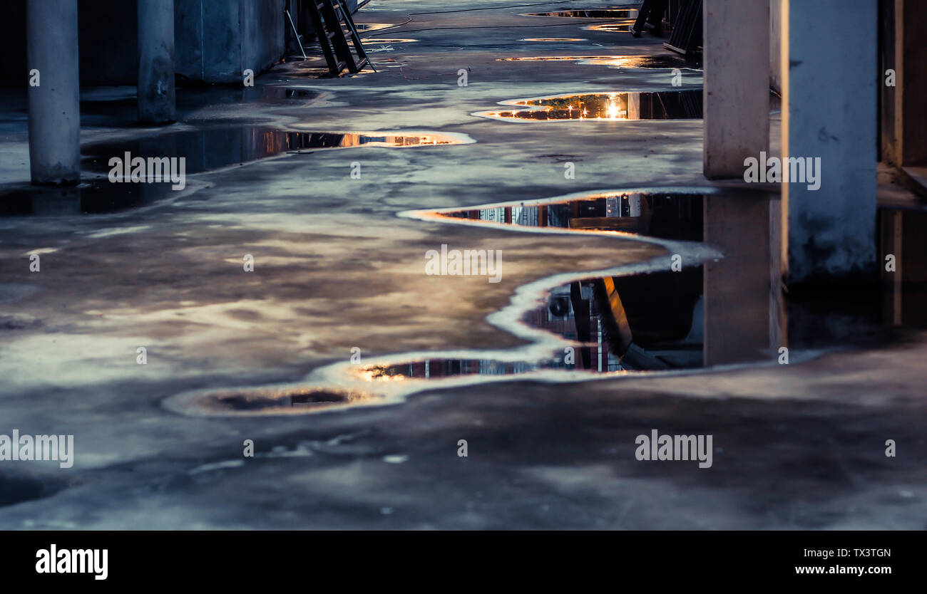 Puddle water reflection on ground. Parking lot with abstract water ...