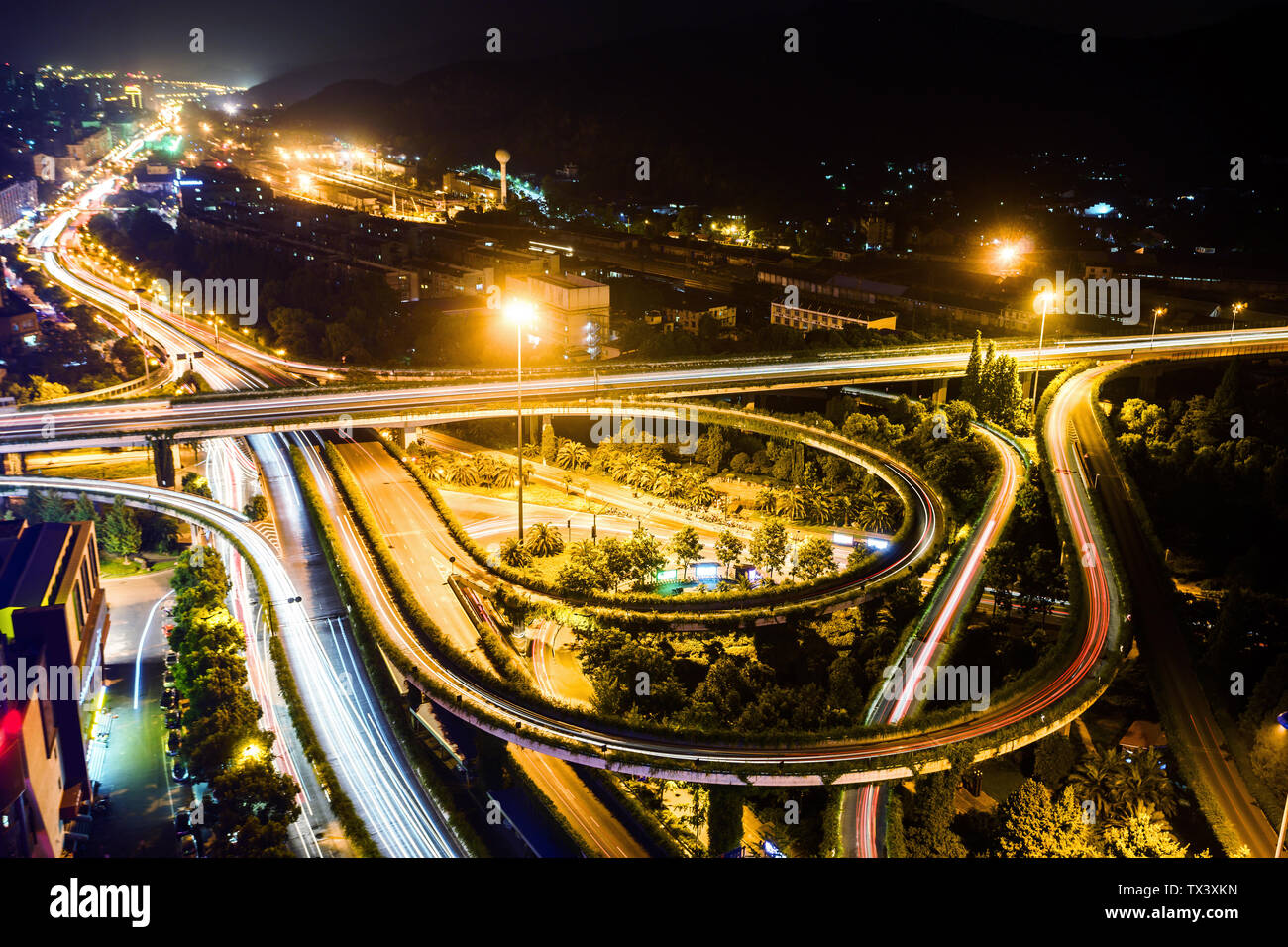 viaduct among modern skyscrapers with people at night Stock Photo - Alamy