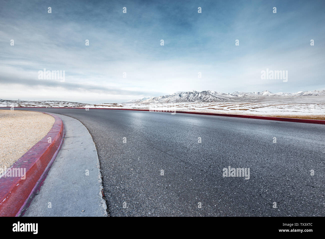 empty asphalt road with snow mountains in blue sky Stock Photo - Alamy