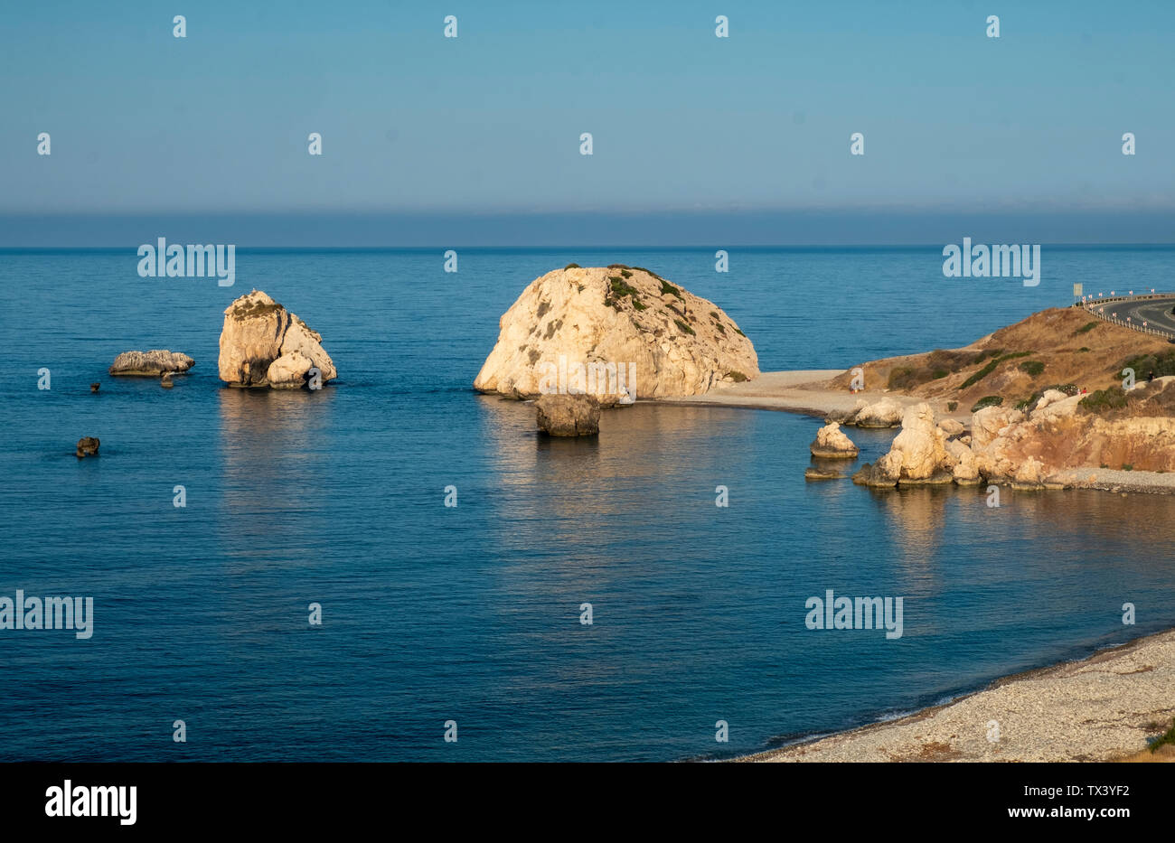Early morning sunshine illuminates Aphrodite's Rock (Petra Tou Romiou ...