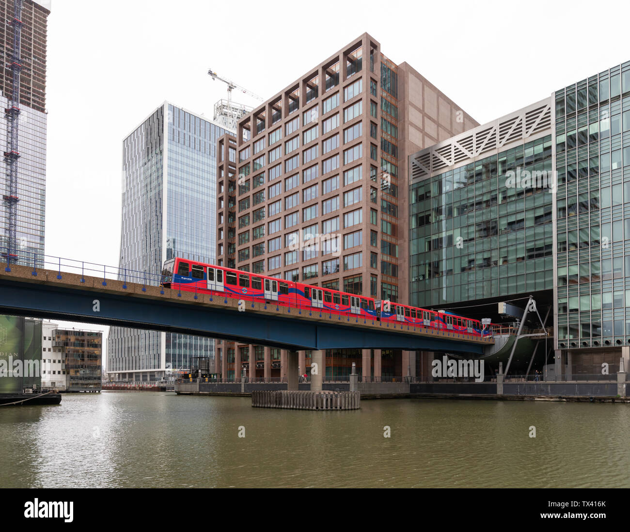 Canary Wharf, London, UK: A Docklands Light Railway train emerges from ...