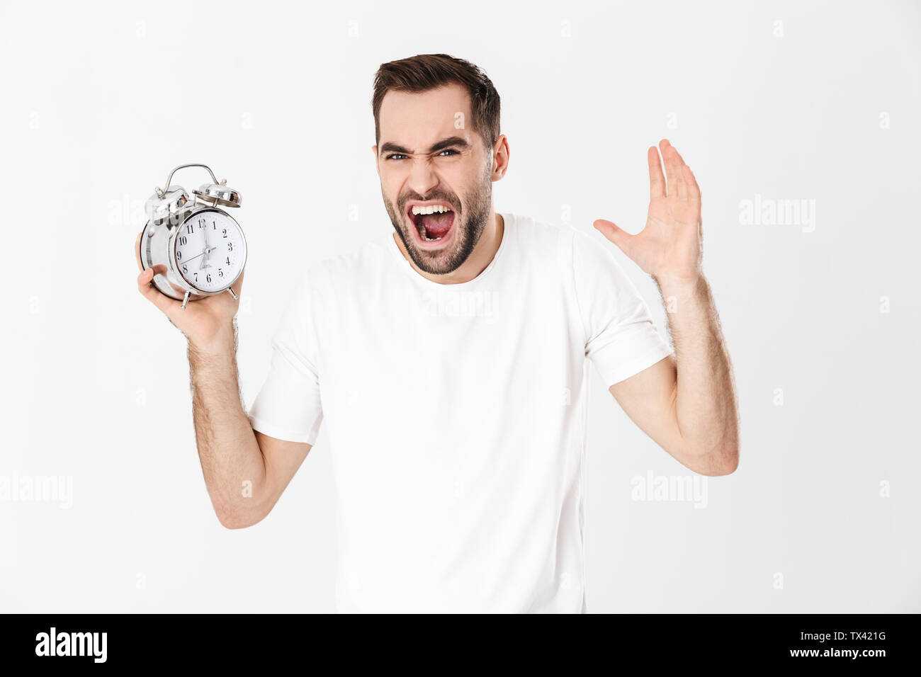 Handsome angry man wearing blank t-shirt standing isolated over white ...