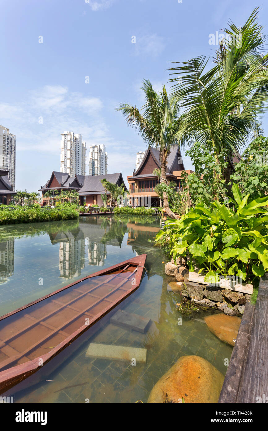 boat stop in water with resort building exterior Stock Photo - Alamy