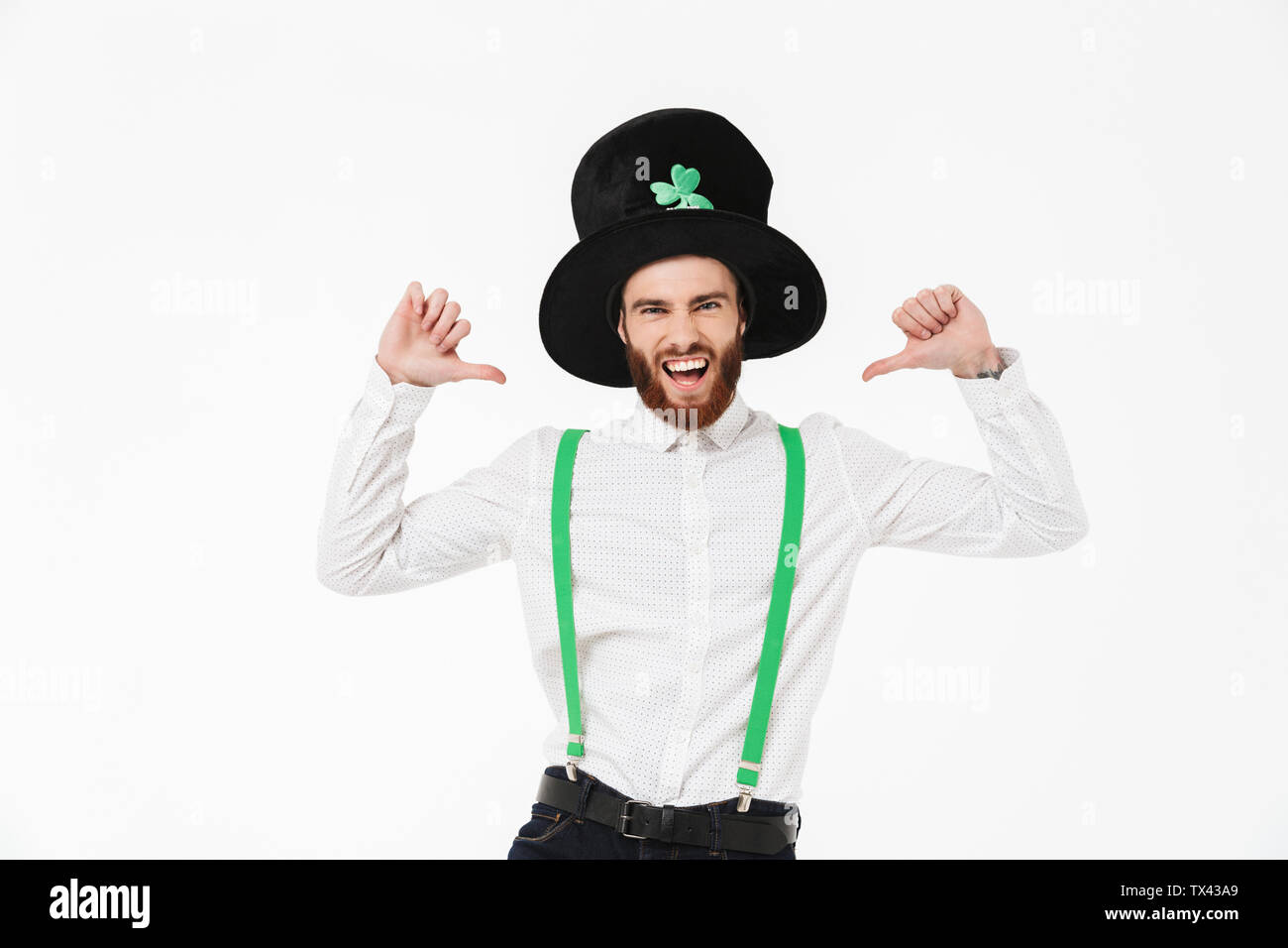 Cheerful young man celebrating St.Patrick 's Day isolated over white ...