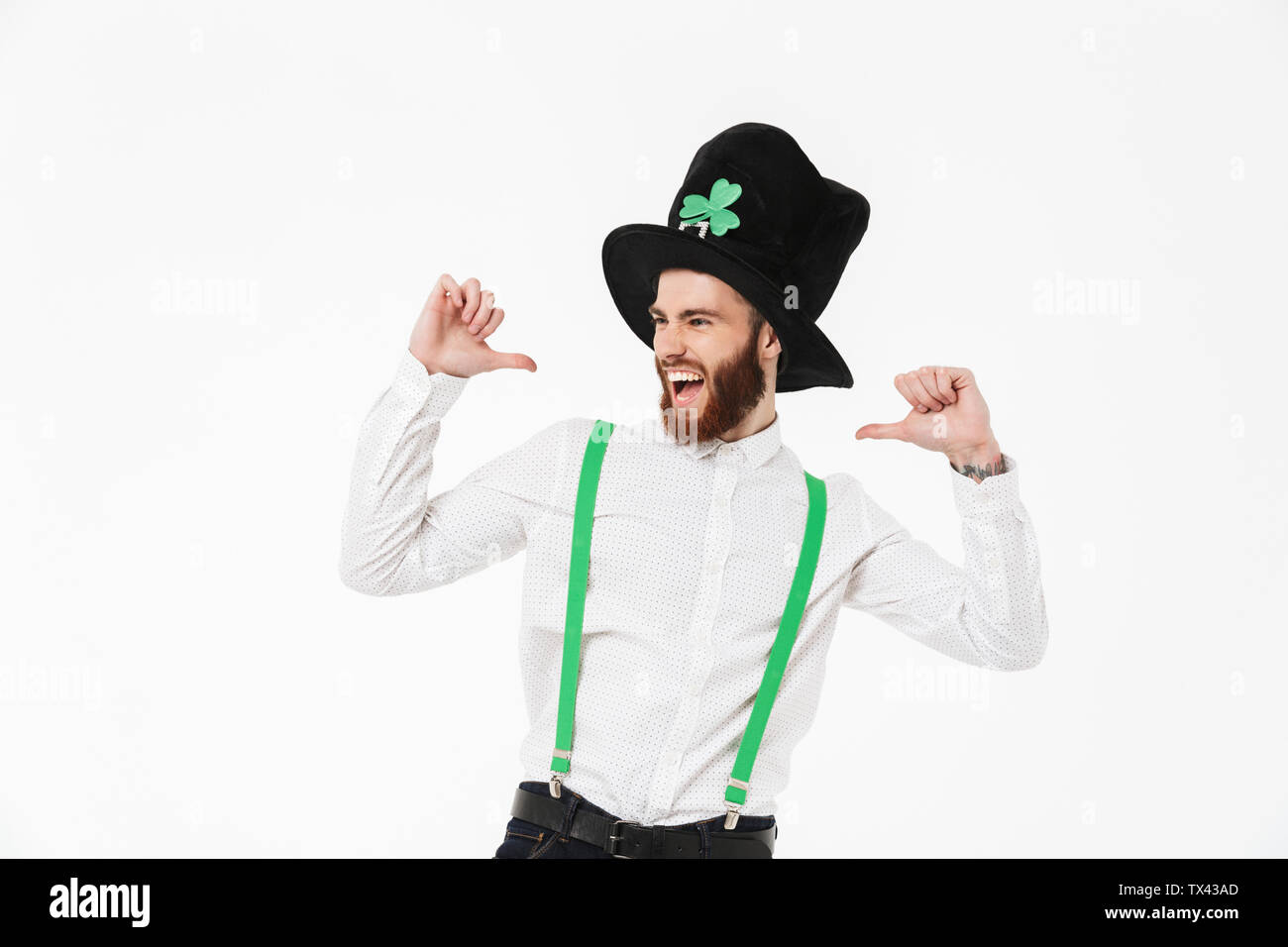 Cheerful young man celebrating St.Patrick 's Day isolated over white ...