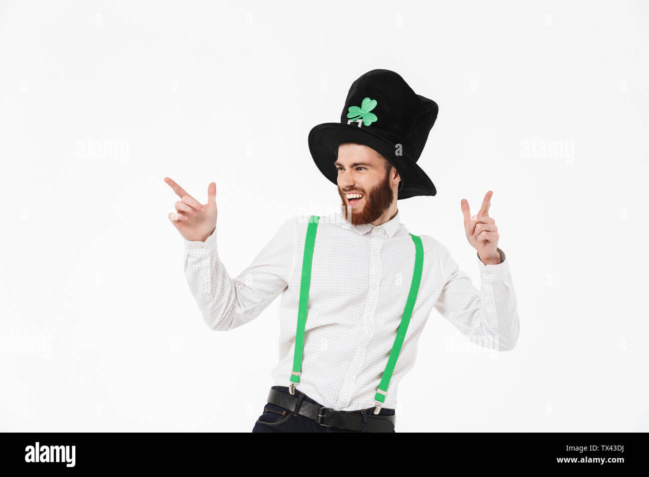 Cheerful young man celebrating St.Patrick 's Day isolated over white ...