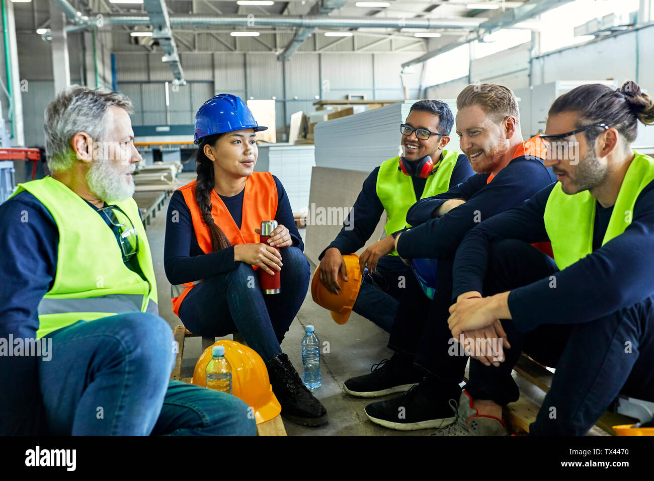 Workers in factory having lunch break together Stock Photo - Alamy