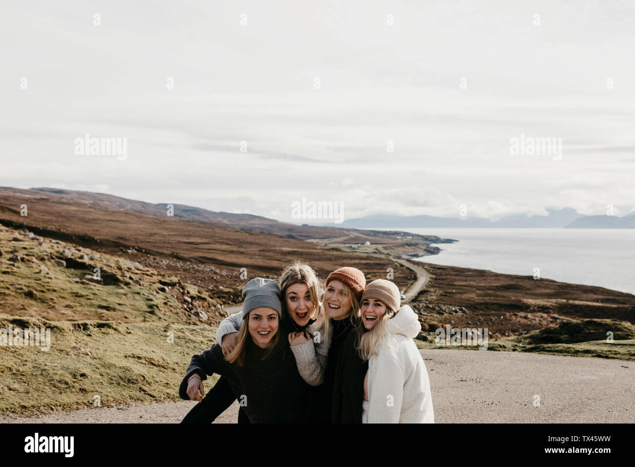 Happy Female Friends On A Road At The Coast High Resolution Stock ...