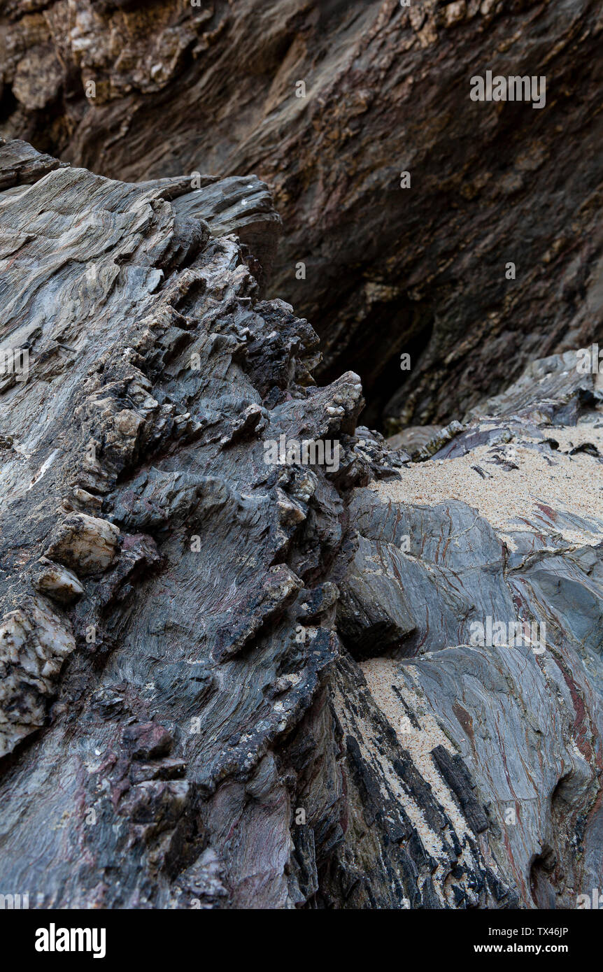 Surface of rocky wall with different hardnesses where the parts of the ...