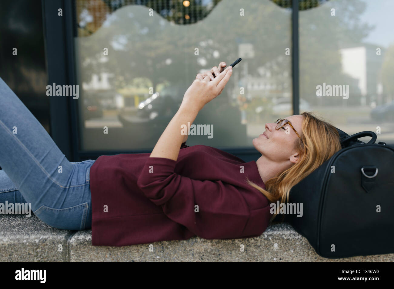 Blonde woman phone back view hi-res stock photography and images - Alamy