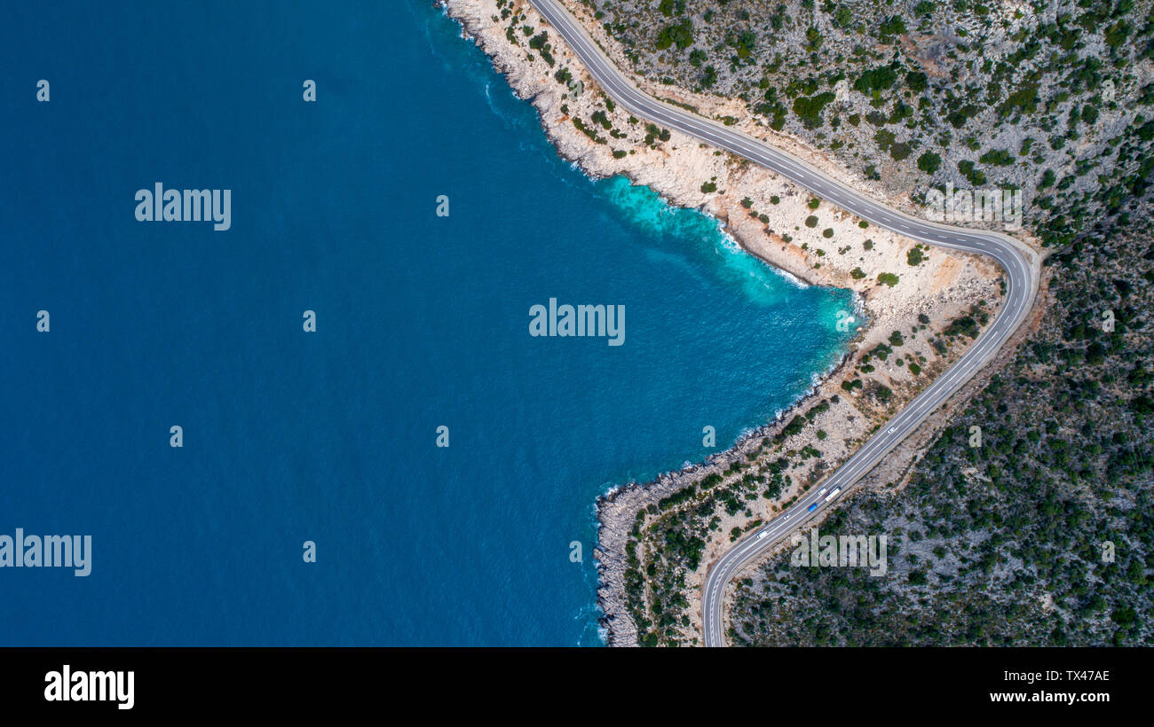 Aerial landscape of coastline and a road seascape. Car drives down the ...
