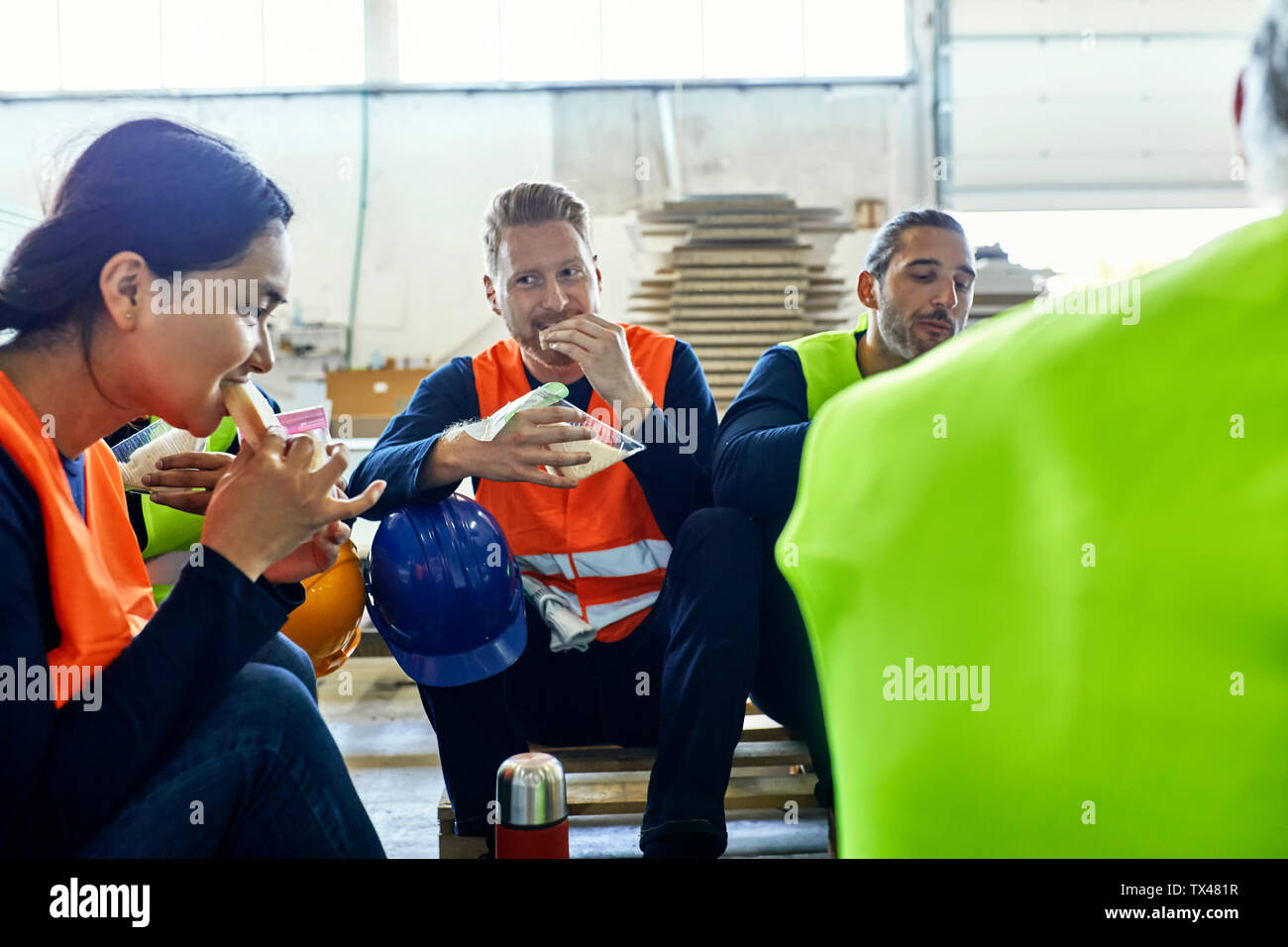 Workers in factory having lunch break together Stock Photo - Alamy