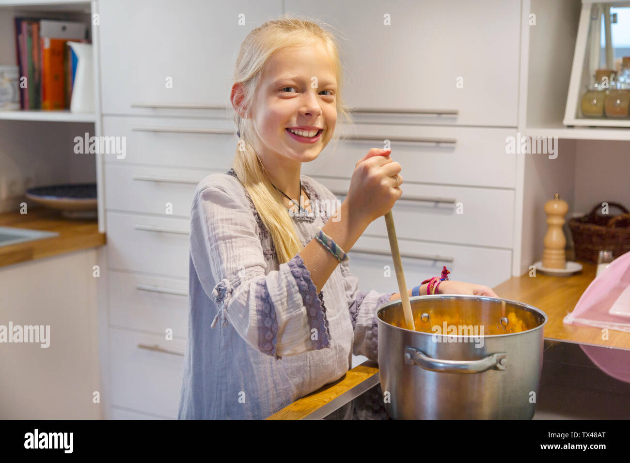 Cute blond girl cooking hi-res stock photography and images - Alamy